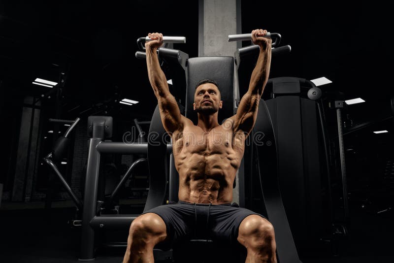 Shirtless Muscular Bodybuilder Training Back on Simulator. Stock Image ...
