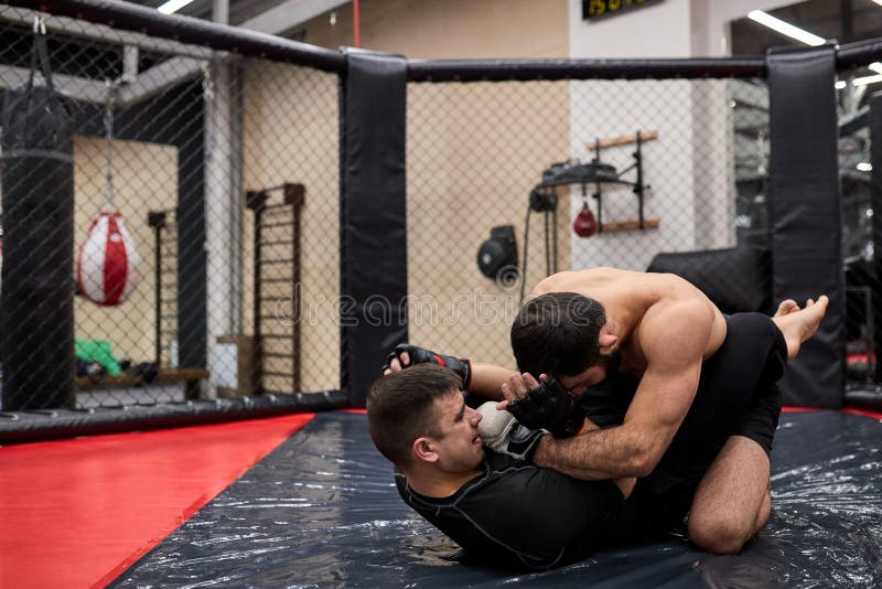 Shirtless Strong Mma Fighter in Boxing Gloves Sitting Above Opponent ... Shirtless Strong Mma Fighter in Boxing Gloves Sitting Above Opponent ...