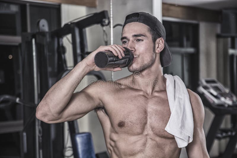 Shirtless Young Man Drinking Protein Shake in Gym Stock Photo - Image ...