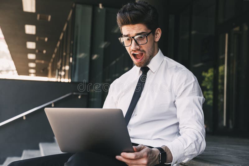 Shocked Business Man Near Business Center Using Laptop Computer. Stock ...