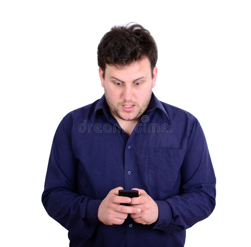 Shocked Businessman Looking At Cell Phone Against White Background