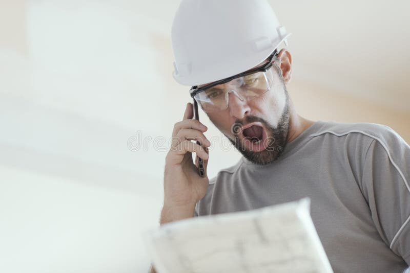 Shocked Construction Engineer Having a Phone Call Stock Photo - Image ...