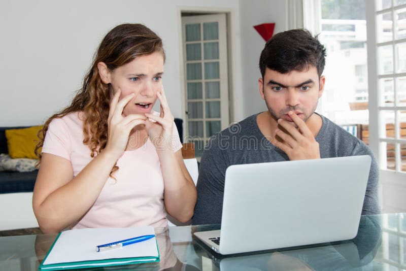Shocked couple at computer stock image. Image of borrowing - 130687175
