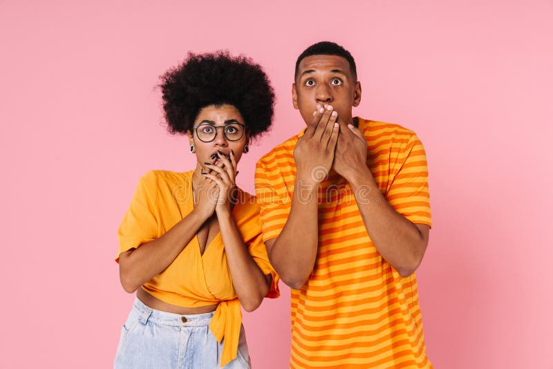 Shocked Couple Covering Their Mouths With Hands Isolated Stock Image