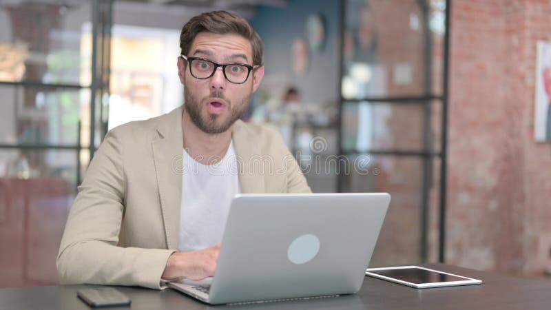 Shocked Young Man Wondering at Work Stock Photo - Image of business ...