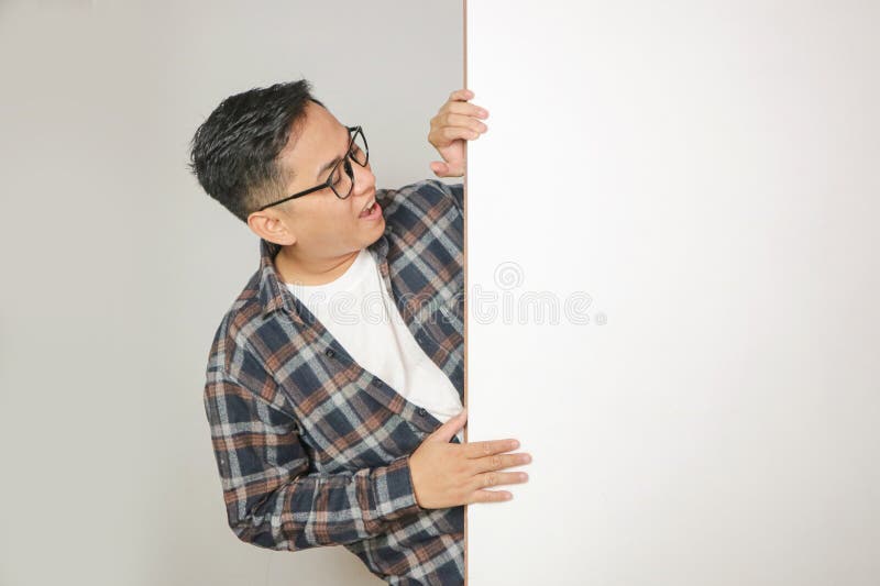 Shocked Expression of Asian Man Looking Side while Holding Banner Blank ...