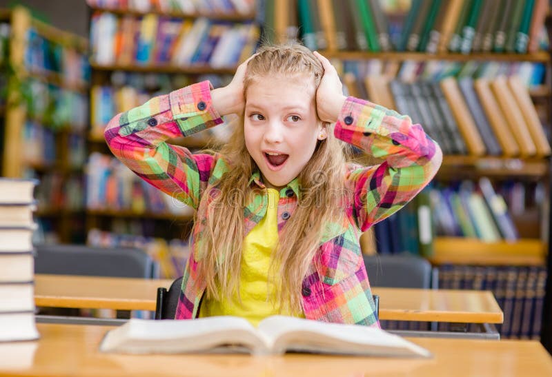 Shocked Girl Reading a Book in the Library Stock Image - Image of book ...