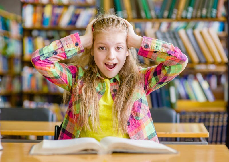 Shocked Girl Reading a Book in the Library Stock Image - Image of book ...