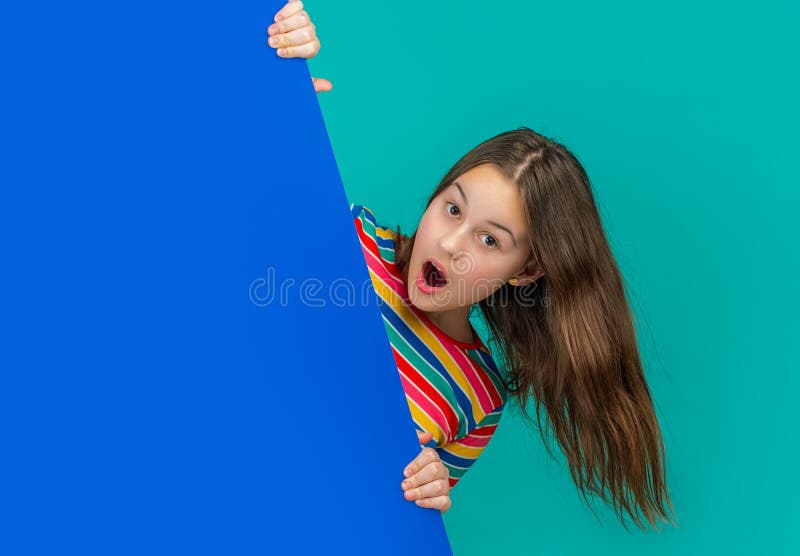 Shocked Kid Behind Blank Blue Paper with Copy Space for Advertisement ...