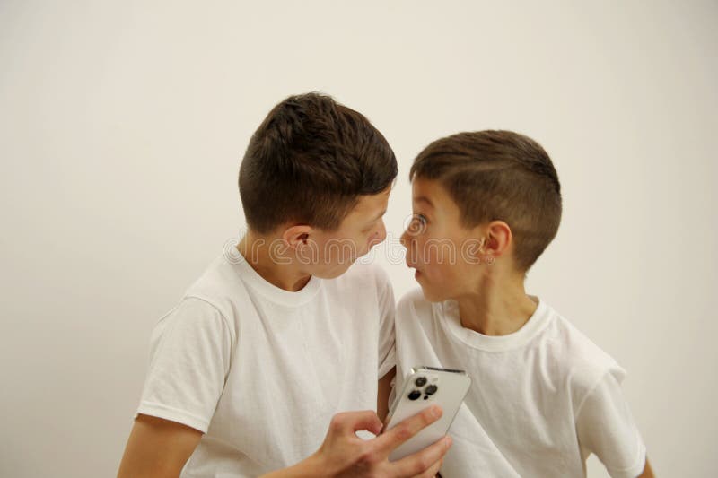 Shocked Kids Using Modern Smartphone with Surprised Emotions and Eyes ...