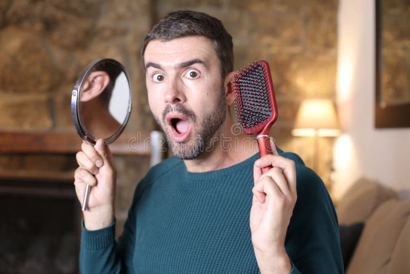Shocked Looking Man Holding Mirror and Comb Stock Photo - Image of ...