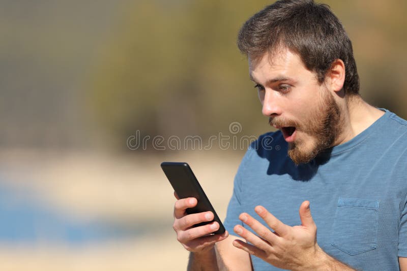 Happy Man Checking Phone Under an Umbrella in Winter Stock Image ...