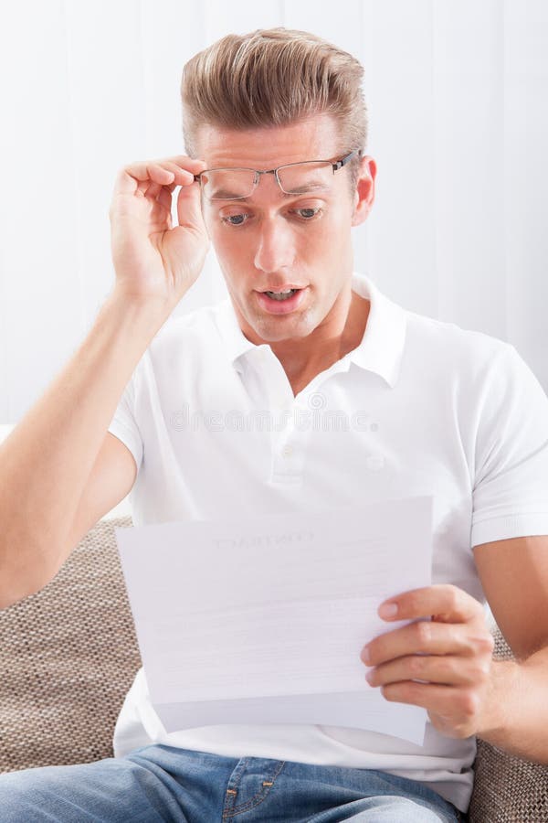 Shocked Man Looking at Paper Stock Photo - Image of businessman ...