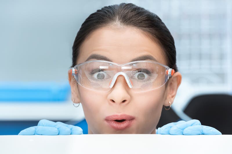 Shocked Scientist Looking Out Behind Table after Experiment in Lab ...