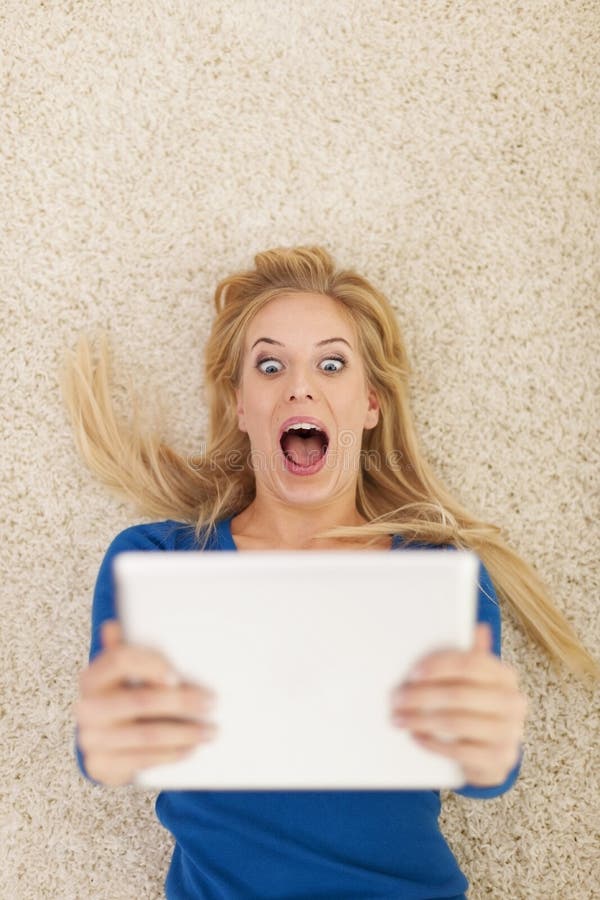 Shocked woman with tablet stock photo. Image of mobility - 36560342