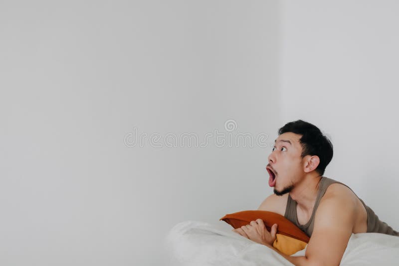 Shocked and Wow Face Man Point at the Empty Space while Lying on ...