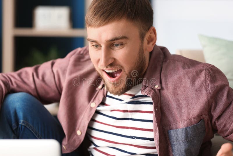 Shocked young man at home stock photo. Image of excited - 151335322