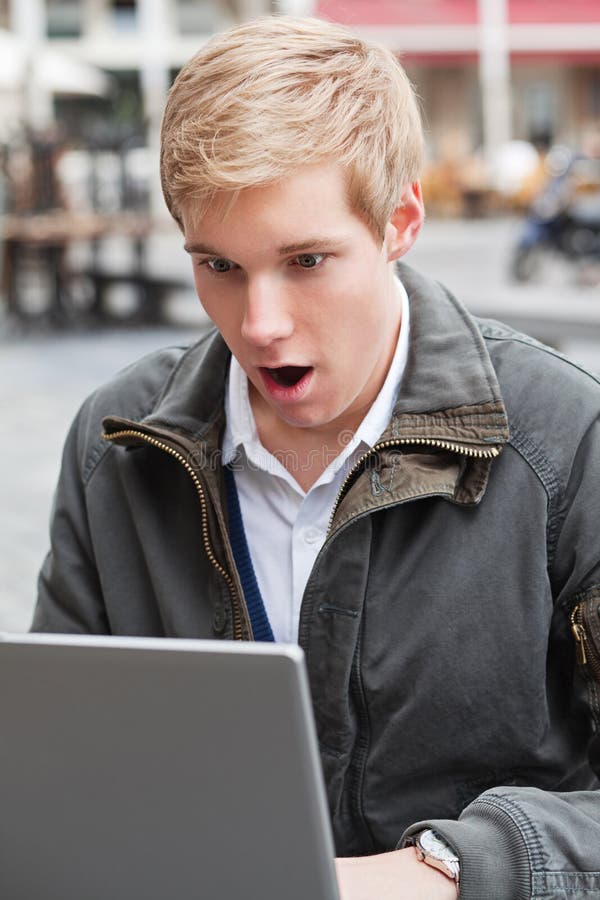 Shocked Young Man with Laptop Stock Photo - Image of sitting, gaze ...