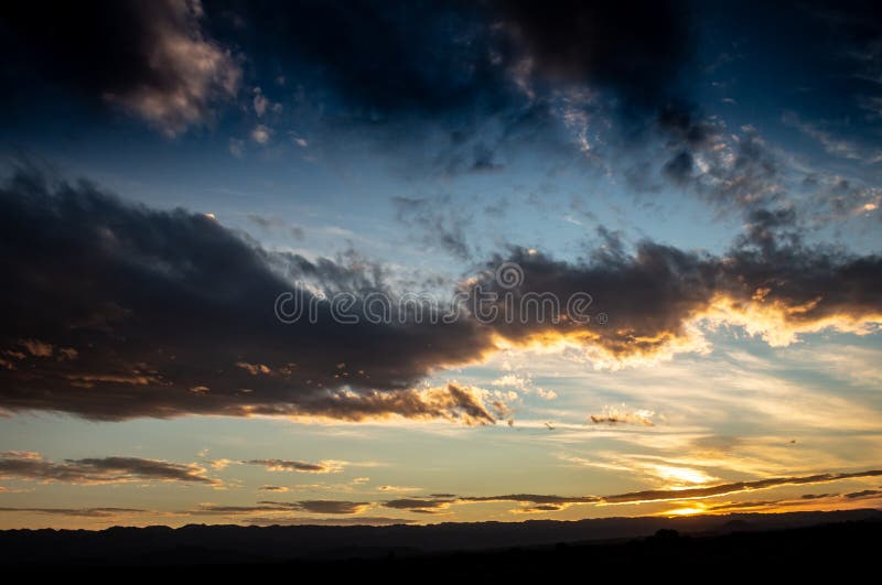 Shocking Sunset between the Field. Landscape with Distant Mountains ...
