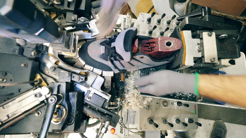 Shoe Manufacturing Worker Using a Shoe Making Machine at Factory ...
