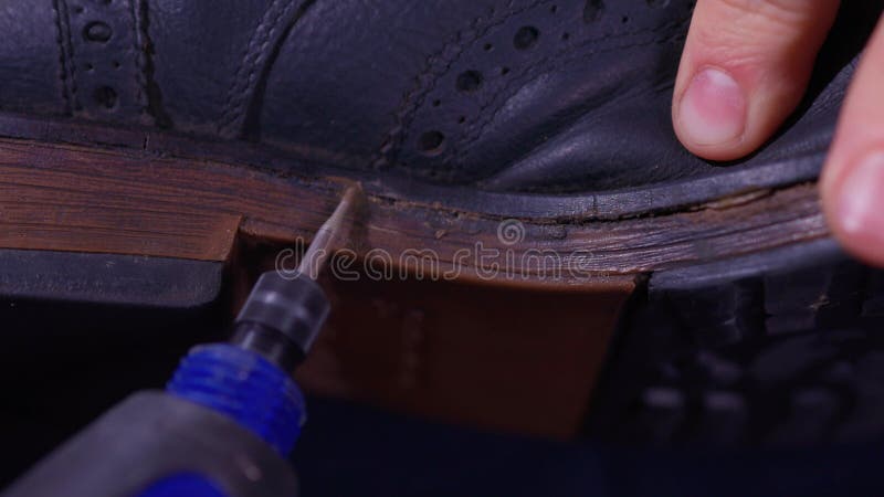 A Shoemaker Cuts the Sole of a Shoe with a Shoemaker S Automatic Cutter ...