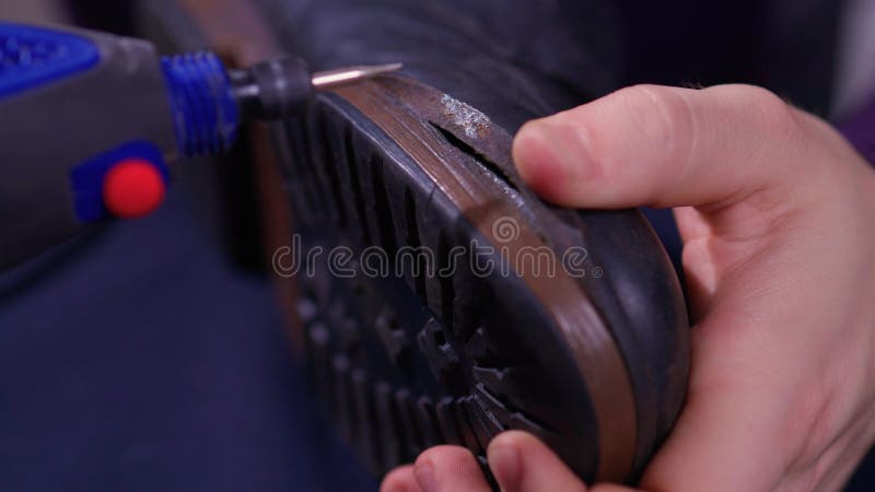 A Shoemaker Cuts the Sole of a Shoe with a Shoemaker S Automatic Cutter ...