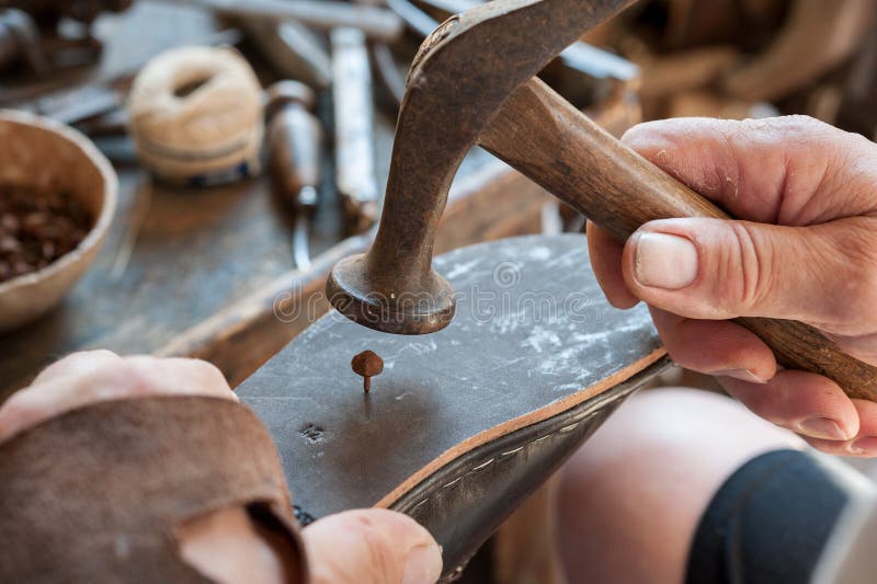 The Shoemaker Repairs a Shoe at His Work Bench Stock Photo - Image of ...