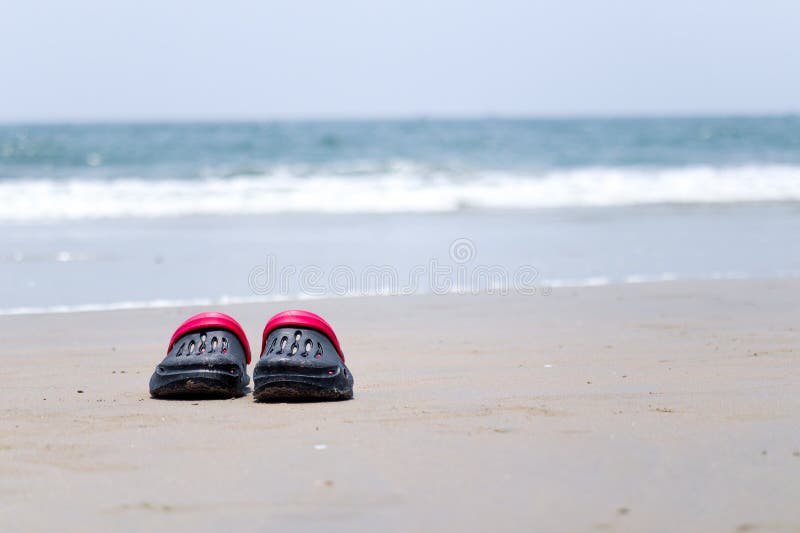 The Shoes Kept Near the Beach with Waves of Ocean are in the Background ...
