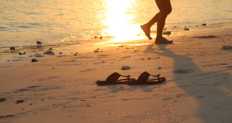 The Shoes Were Placed on the Beach at Sunset. Stock Image - Image of ...