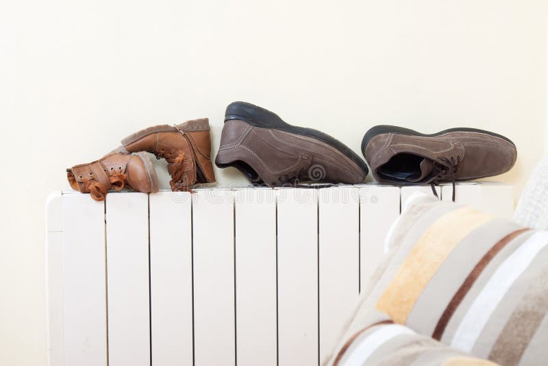 Shoes on white radiator stock image. Image of oneself - 48087361