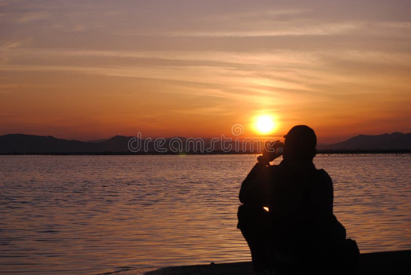 Shoot the Sun stock image. Image of sunset, taking, beach - 25210901