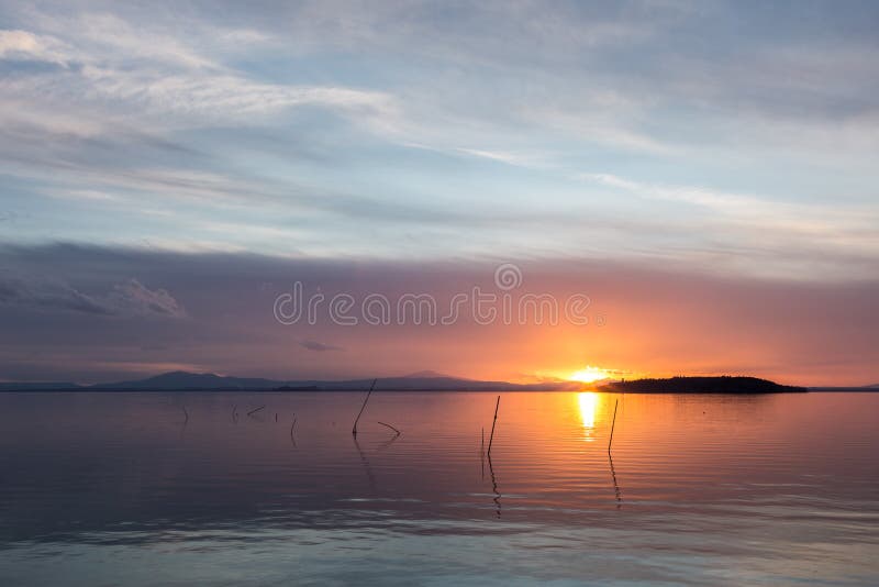 A Shoot of a Sunset Over a Lake, with Beautiful Warm Colors and Clouds ...
