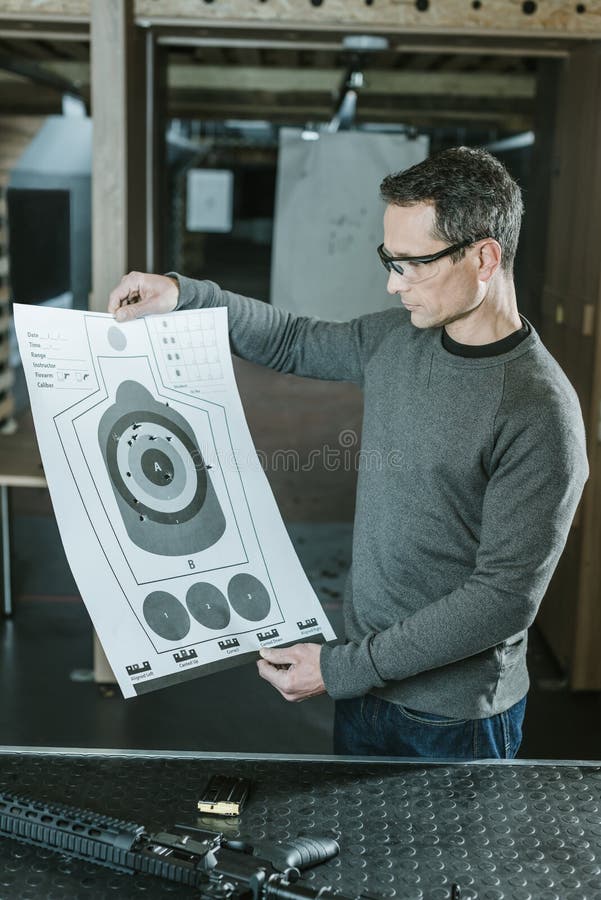Shooter Looking at Used Target after Shooting Stock Photo - Image of ...
