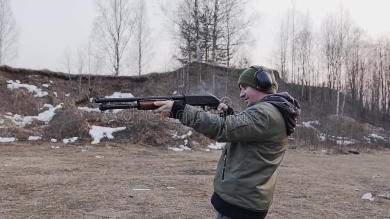 Shooter Takes Two Shots with a Shotgun, Reloading between Shots. Stock ...