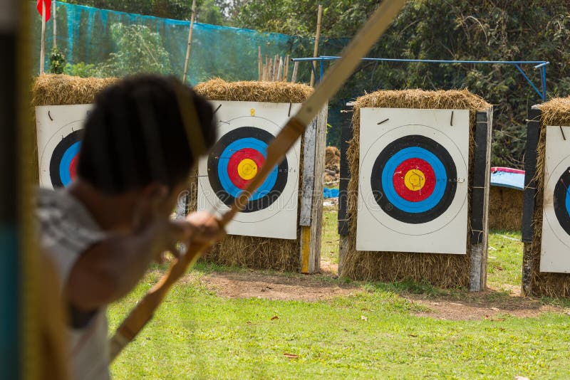 Man Shooting With Bow And Arrow Stock Image - Image of exterior, adults ...