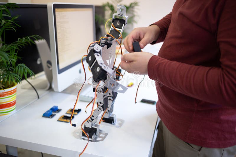 Shooting Close-up. Man Designs a Large Modern Robot Stock Image - Image ...