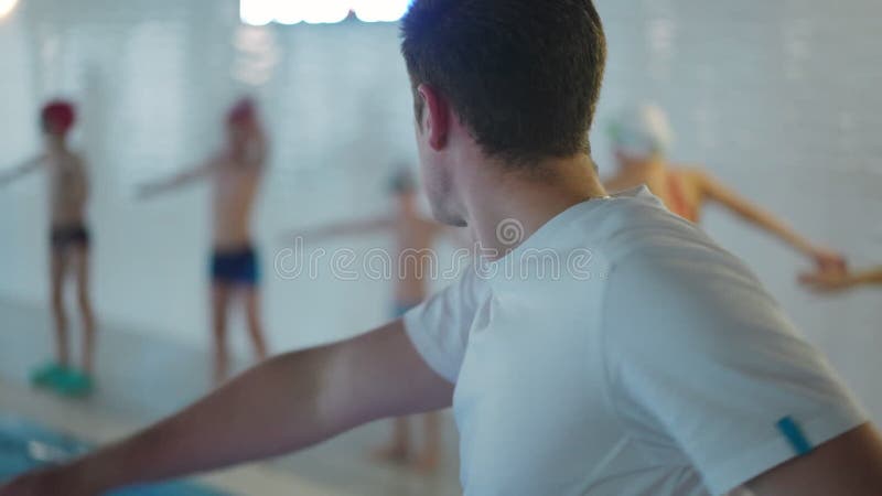 Shooting Over Shoulder of Trainer Training Group of Blurred ...