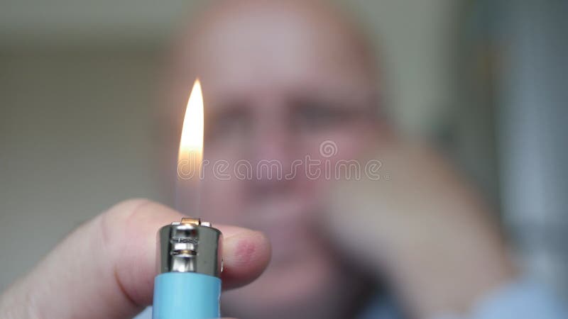 Shooting with a Person Lighting the Flame on a Cigarette Lighter. Stock ...