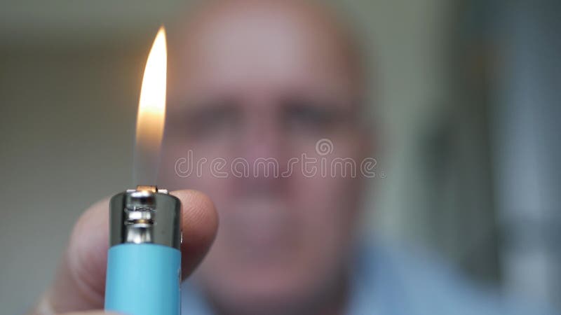 Shooting with a Person Lighting the Flame on a Cigarette Lighter. Stock ...