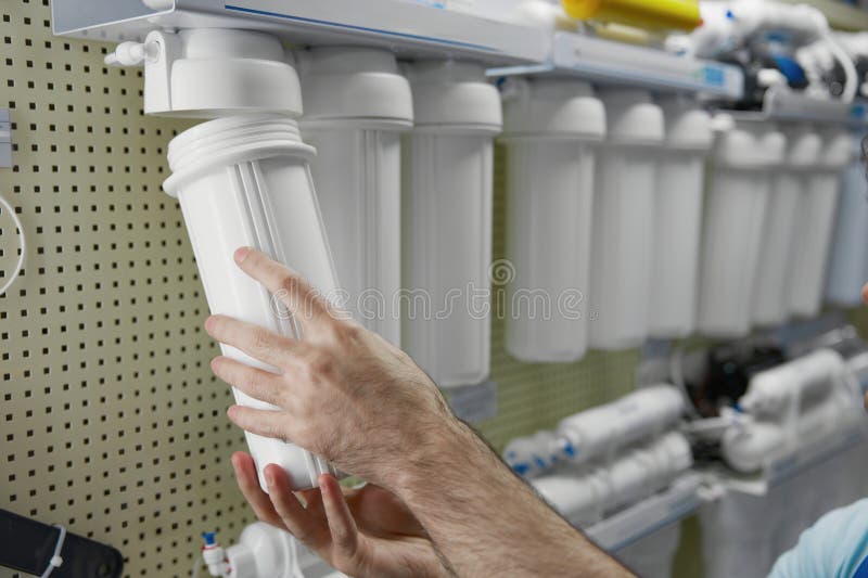 Shop Assistant Checking Filter Equipment Assortment at Plumbing Store ...