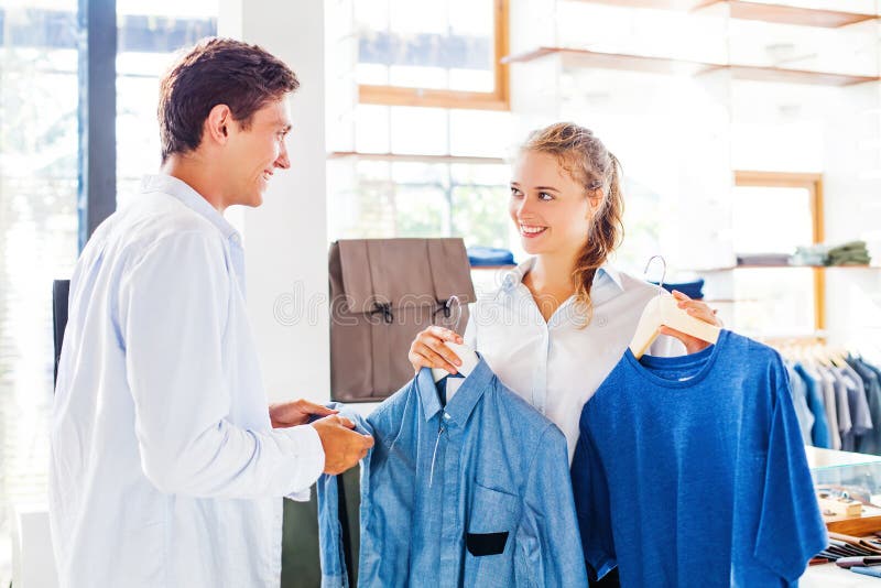 Shop Assistant Helping To Choose Clothes Stock Photo - Image of casual ...