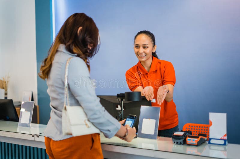 A Shop Assistant Invites Buyers To Scan Barcodes Using His Cell Phone ...