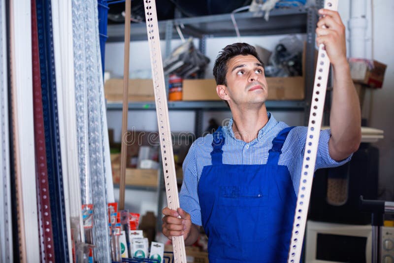 Shop Assistant Man is Choosing Ceiling for Client in Store. Stock Photo ...