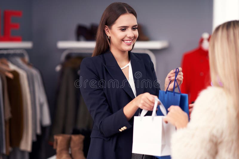 Shop Assistant Serving the Customer in Store Stock Photo - Image of ...