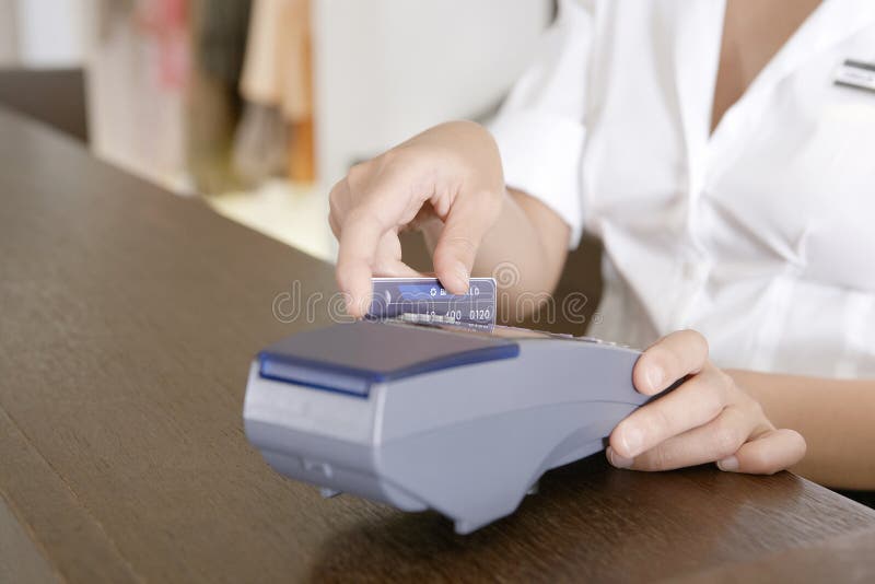 Shop Attendant Sweeping Credit Card at Store Counter Stock Photo ...