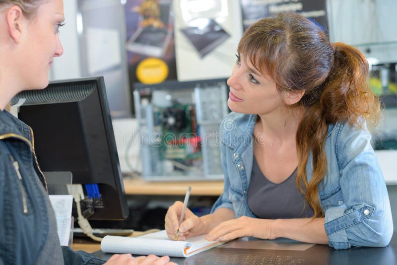 Shop Keeper Taking Notes from Customer Stock Photo - Image of writing ...