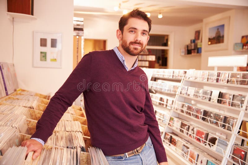 Man and Woman Working Behind the Counter at a Record Shop Stock Image ...