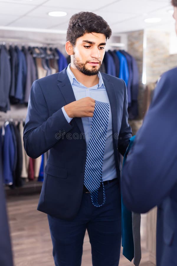 Shopper is Picking Up Tie for Jacket in Front of the Mirror Stock Image ...