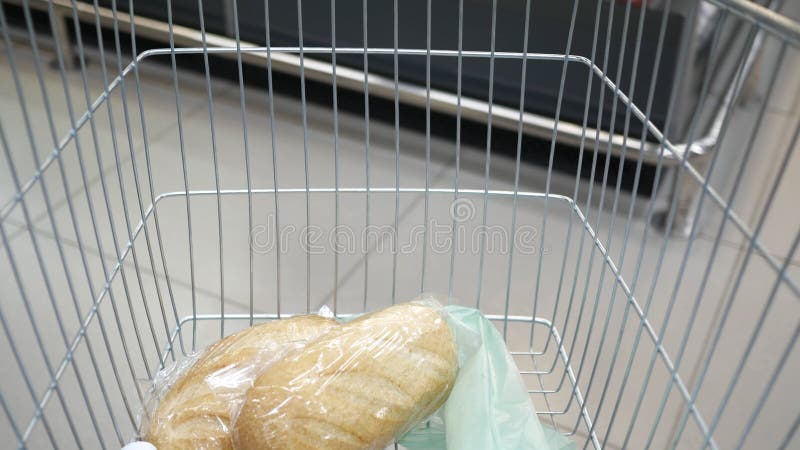 Shopping Cart with Bread Moving through Supermarket Stock Photo - Image ...