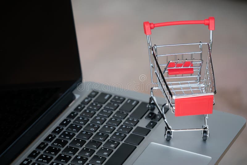 Shopping cart on laptop stock photo. Image of concept - 135048272
